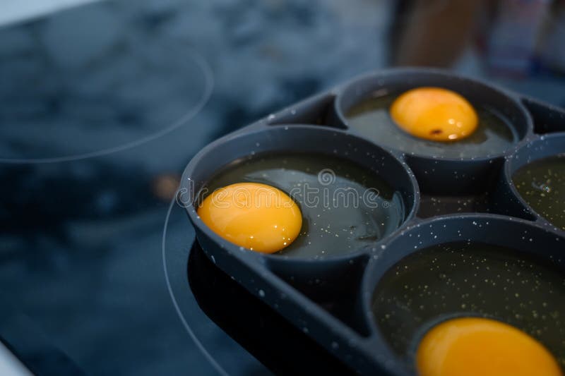 Make Fried Eggs on Black Frying Pan on Electric Stove for Breakfast ...