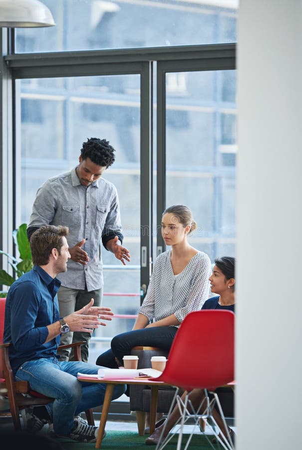 They Make Ideas Reality. a Group of Office Workers Talking Together in ...
