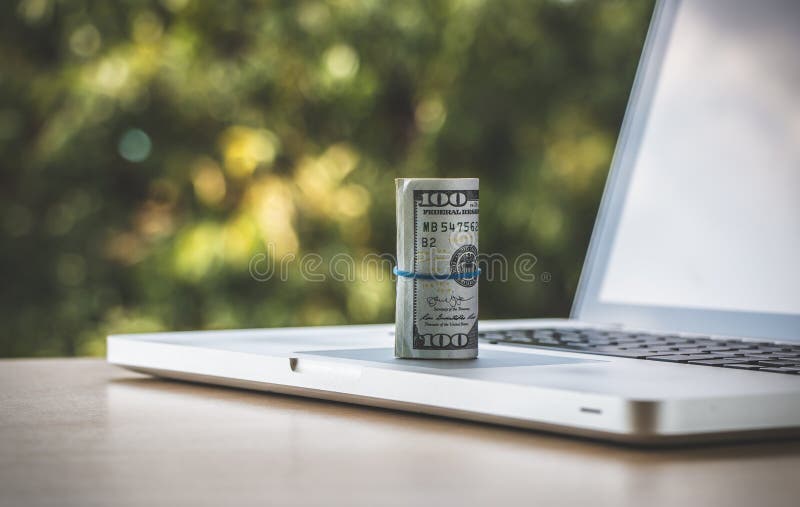 Make Money Online or Online Income Concept. Roll of Dollar Banknotes on ...