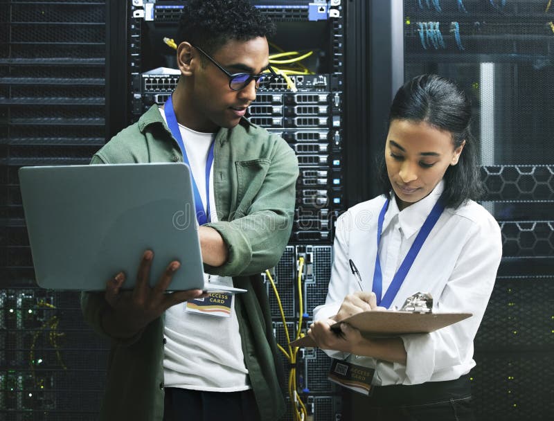 Make a Note of this. Two Technicians Working Together in a Server Room ...