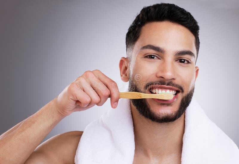 Make those Pearly Whites Shine. a Handsome Young Man Brushing His Teeth ...