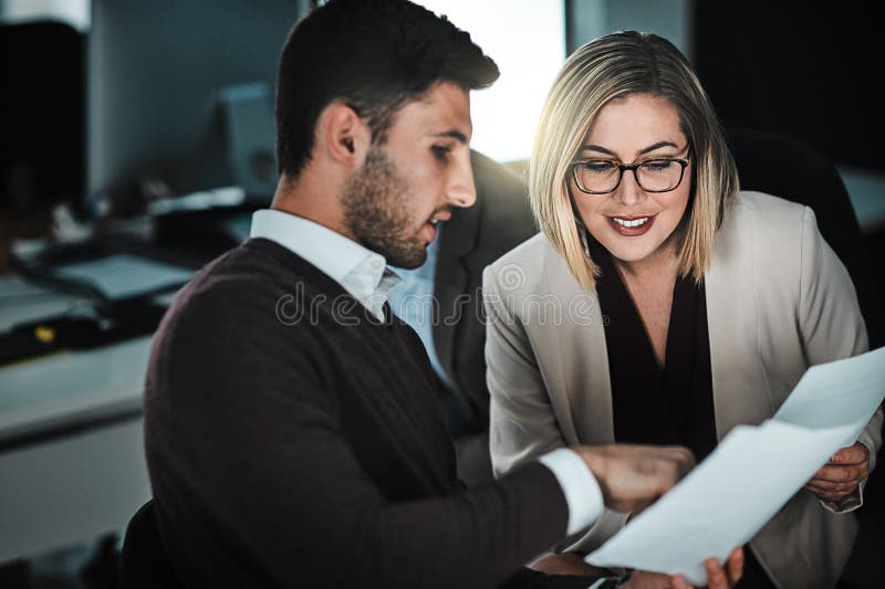 We Make Things Happen. Two Businesspeople Discussing Paperwork. Stock ...