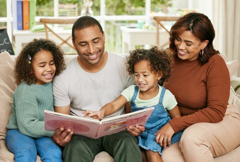 Always Make Time for Family. a Young Family Reading a Book at Home ...