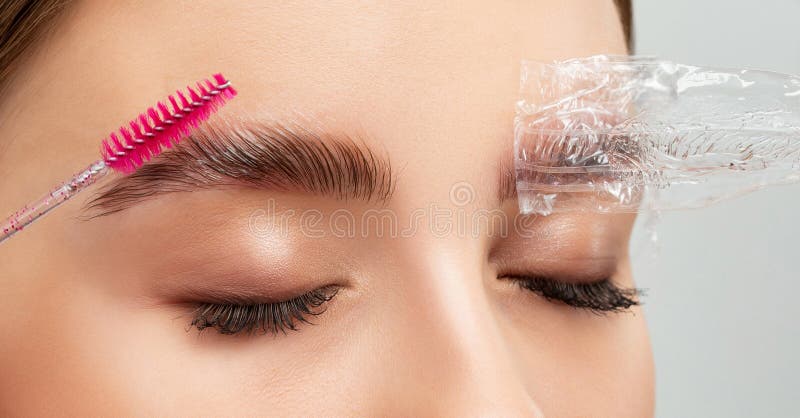 The Make-up Artist Does Long-lasting Styling of the Eyebrows of the ...