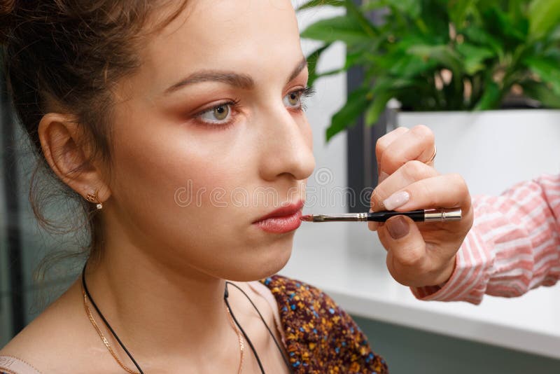 Make-up Artist Evens Out the Tone of the Lips of the Model Stock Photo ...