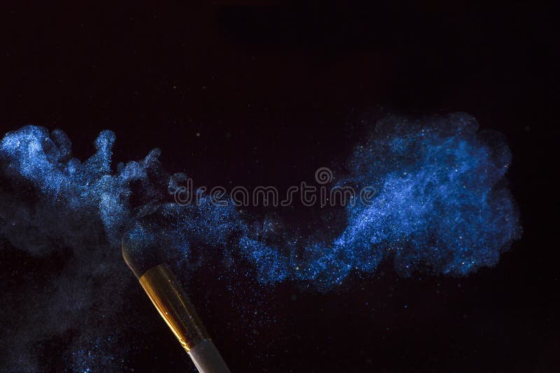 Make-up Brush with Blue Powder Explosion Isolated on Black Background ...
