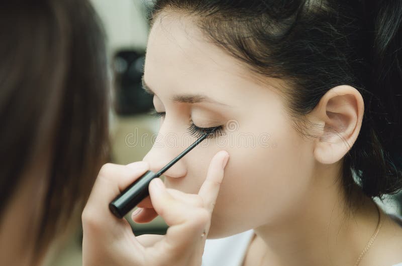The Make-up Master Paints the Eyes of the Girl. Makes Makeup, Close-up ...