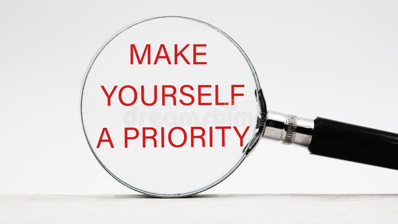 Make Yourself a Priority Text through a Magnifying Glass on a Light ...