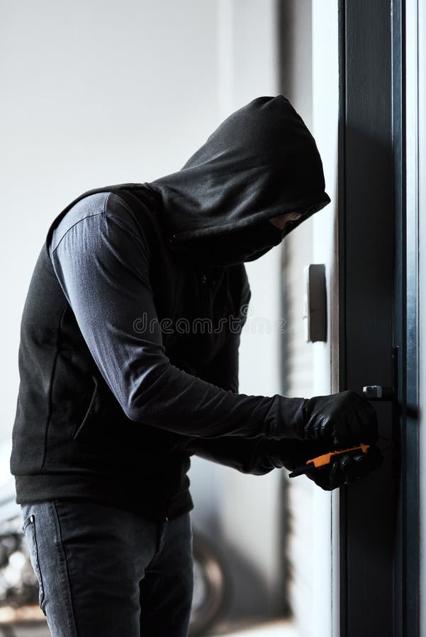 He Makes it Look so Easy. a Masked Criminal Busy Picking the Lock of a ...