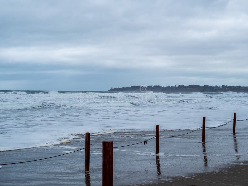 Makeshift Fence of Wooden Posts and Strings on a Storm Beach with Waves ...