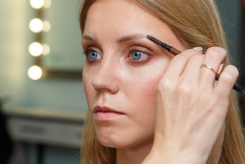 Makeup Artist Emphasizes Eyebrows on Model`s Face Stock Photo - Image ...