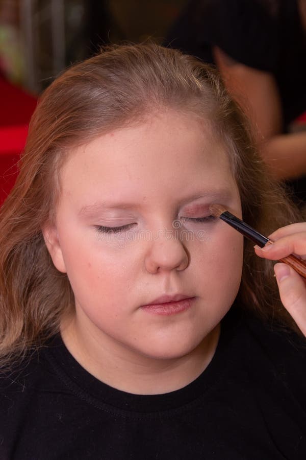 A Makeup Artist Makes Makeup for a Child. Stock Photo - Image of ...