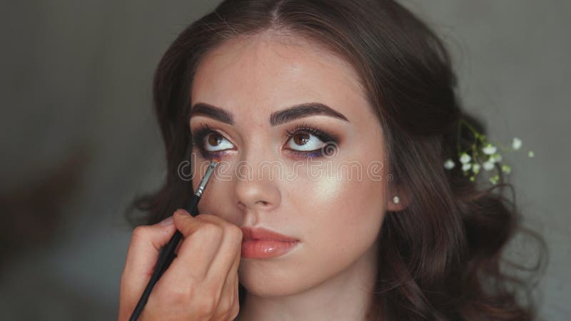 Makeup Artist Paints an Eye for a Model Girl. Stock Photo - Image of ...