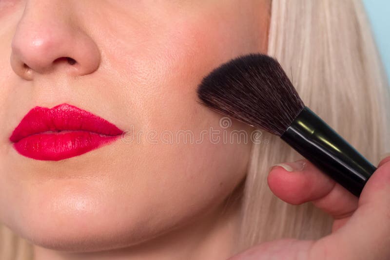 Makeup Artist Paints a Woman Blush Cheekbones. Makeup. Stock Photo ...