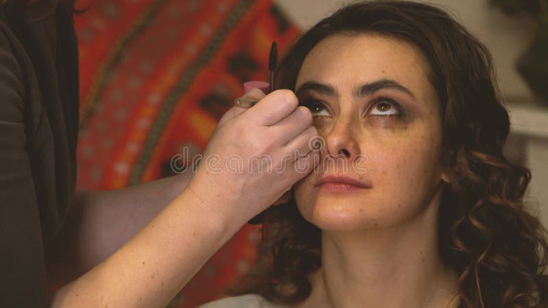 Makeup Artist Tint the Lower Eyelids of a Girl Model Stock Video ...