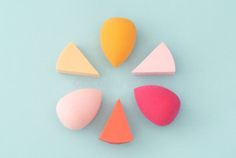 Makeup Sponges Triangular and Round Shapes on a Blue Background Stock ...