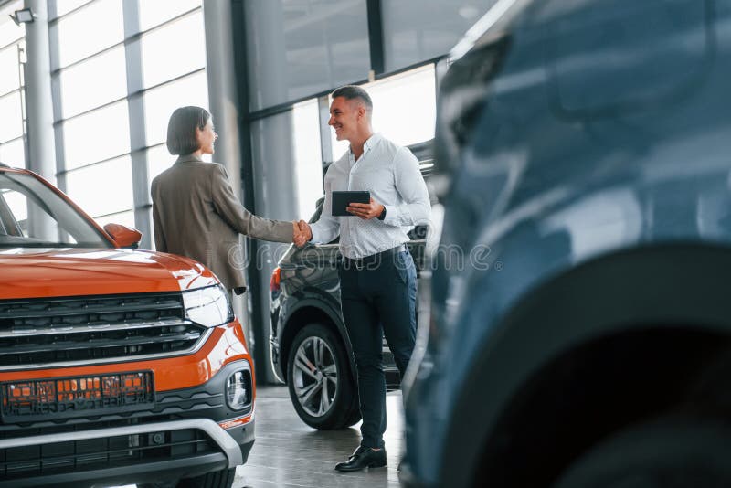 Making Agreement. Man in Formal Wear Helping Customer with Choice of ...