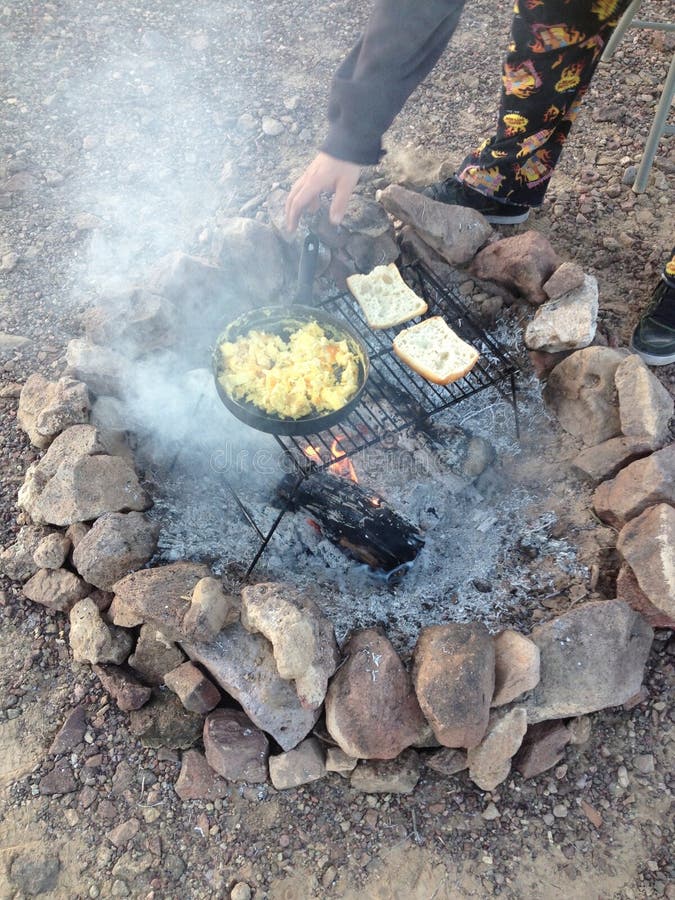 Making Breakfast Over the Campfire Wearing Pajamas Stock Photo - Image ...