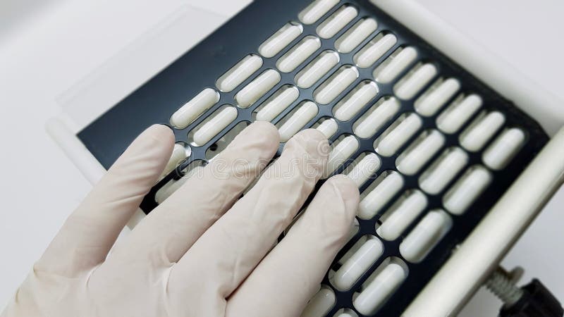 White capsules compounding stock image. Image of machine - 141883163