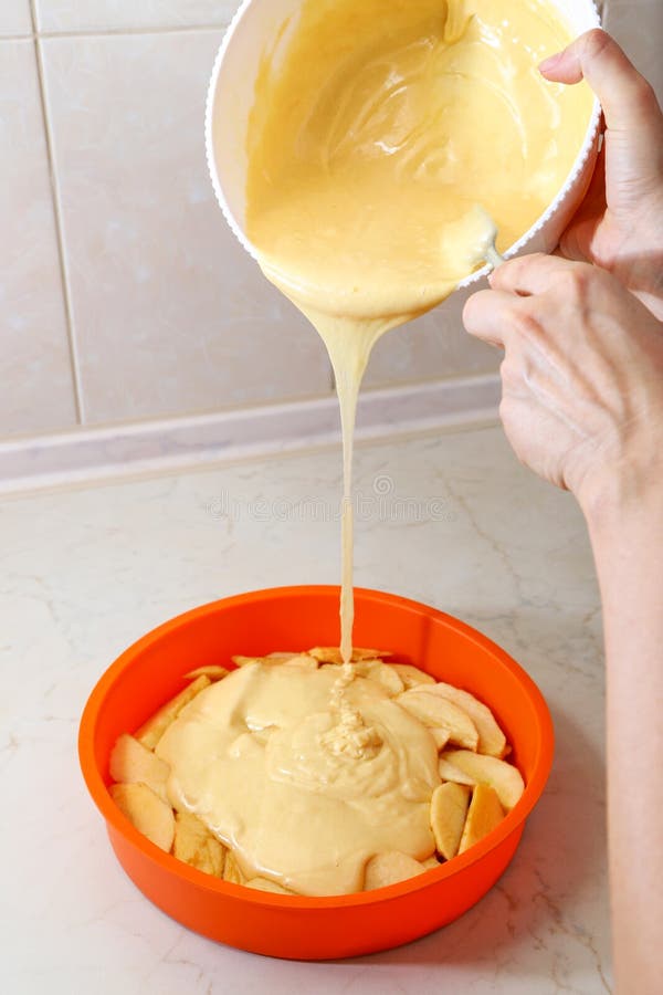 Making Charlotte Apple Pie. Pouring the Batter into the Cake Pan on Top ...