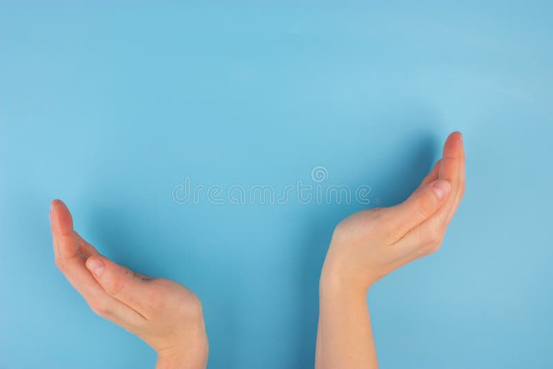 Making a Choice between Two Alternatives. Hands on Blue Background ...