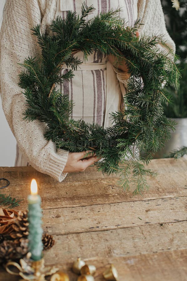 Making Christmas Rustic Wreath. Woman Holding Stylish Christmas Wreath ... Making Christmas Rustic Wreath. Woman Holding Stylish Christmas Wreath ...