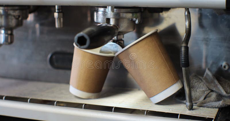 Making Coffee by Coffee Machine into Cups, Espresso Coffee Coming Out ...