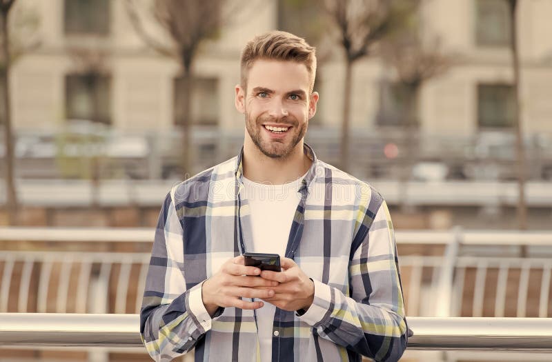 Making Communication Easier. Happy Guy Use Smartphone Outdoors. Mobile ...