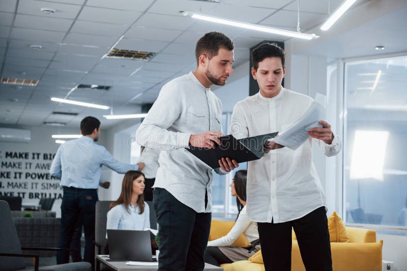 Making Corrections in Report. Two Office Workers in Classic Clothes ...