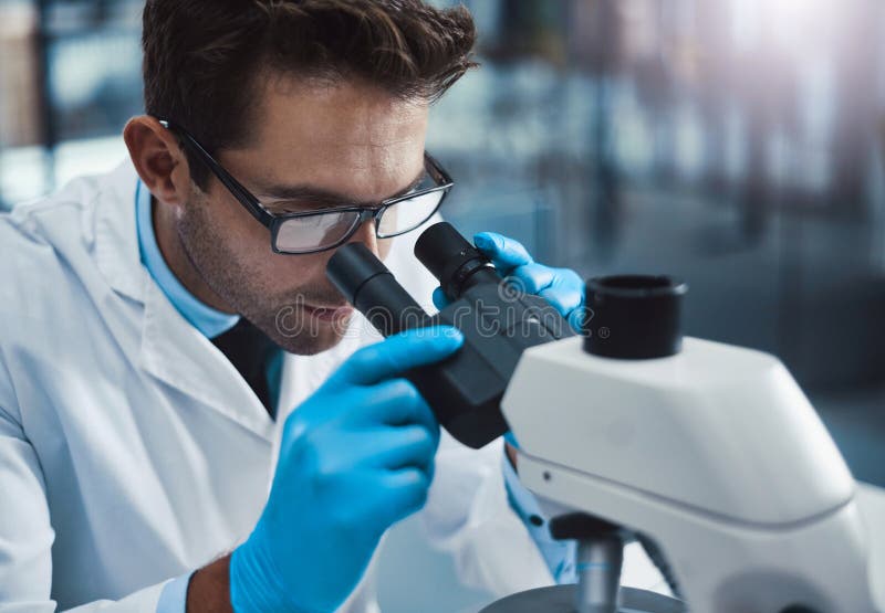 Making Discoveries One Look at a Time. a Young Male Scientist Working ...