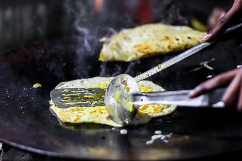 Making of Egg Roll on a Hot Frying Pan with Oil and Paratha and Salad ...