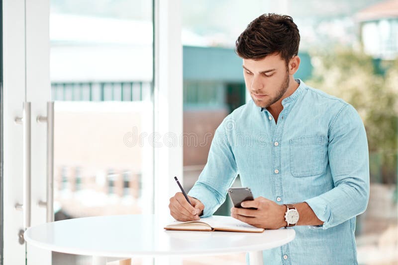 Making a Few Personal Notes. a Handsome Young Businessman Making Notes ...