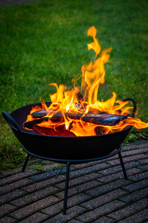 Making a Fire in a Fire Bowl with Burning Wood Stock Photo - Image of ...