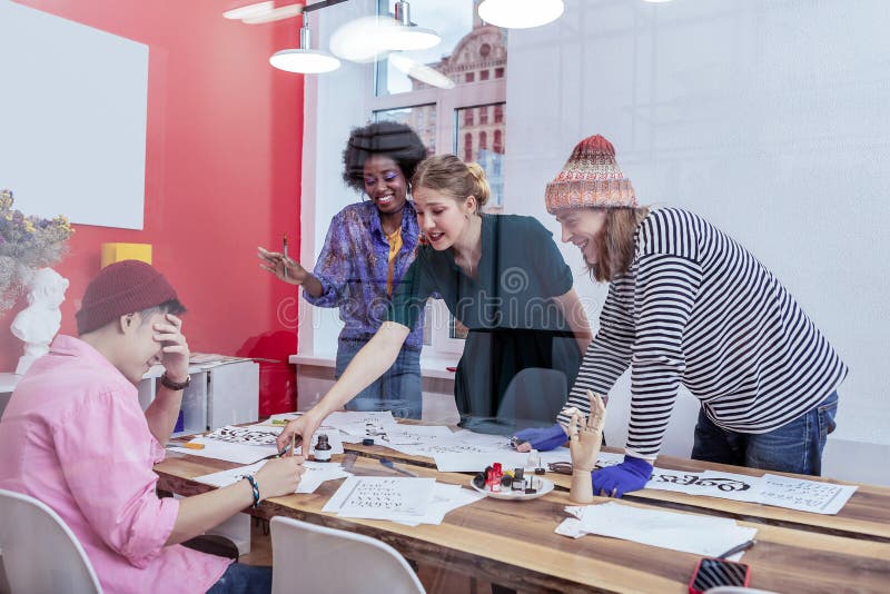 Three Creative Managers Making Fun of Their Young Colleague Stock Photo ...