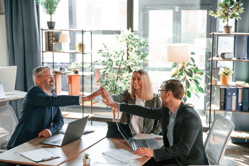 Making High Five, Sitting by the Table. Group of Business People are ...