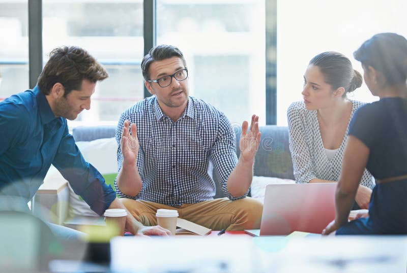 Making an Important Point. Shot of a Group of Office Workers Talking ...