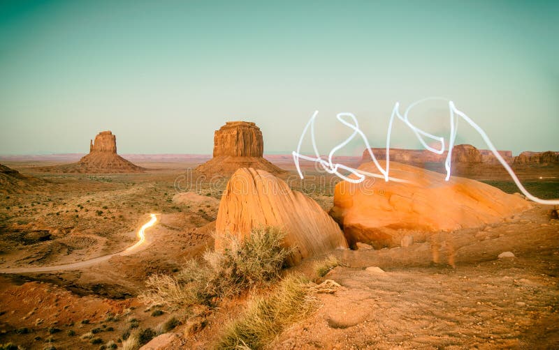 Making Light Signs with Torch in the Monument Valley Night Stock Photo ...
