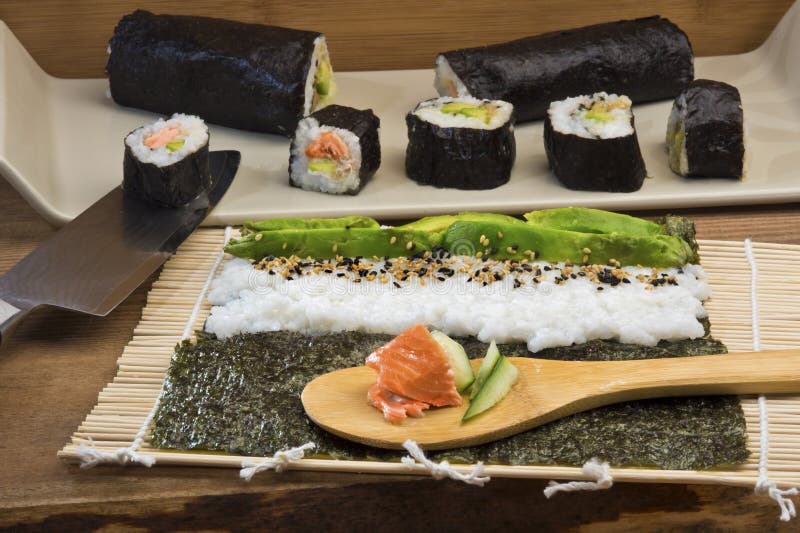 Making maki sushi rolls stock photo. Image of cucumber - 52356644