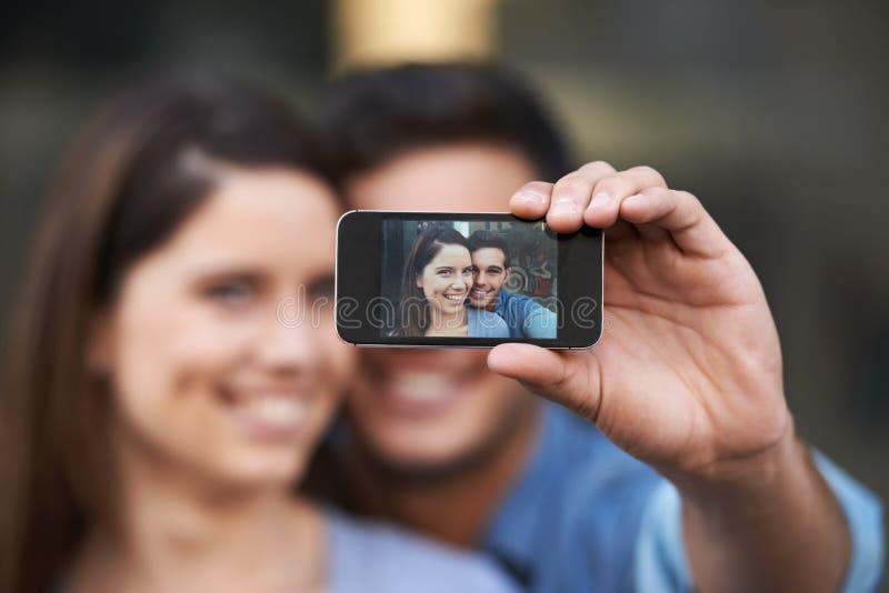 Making Memories A Young Couple Taking A Self Portrait With A Cell