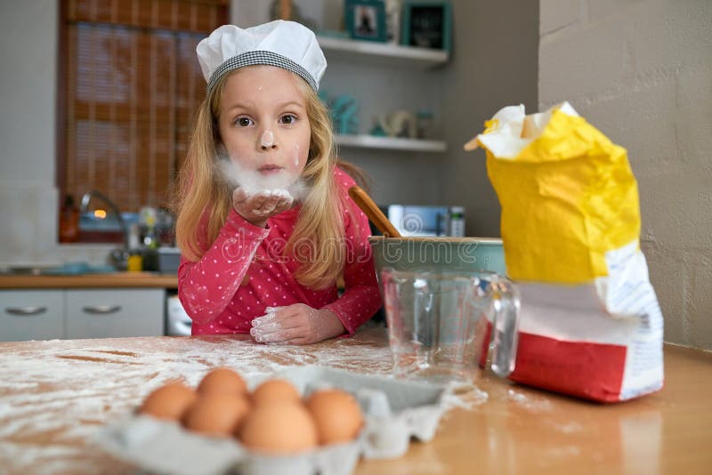 Making a Mess is Half the Fun. a Little Girl Baking in the Kitchen ...