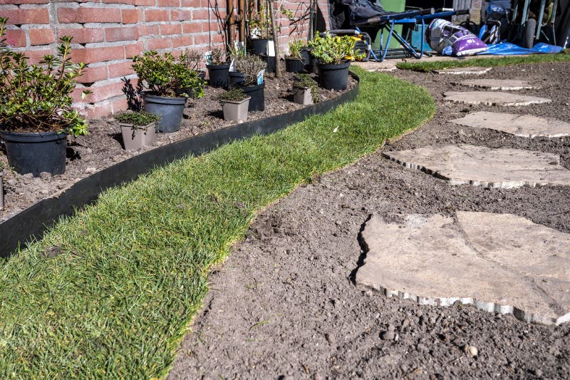 Making of Natural Green Lawn in Garden with Rolls of Green Grass ...