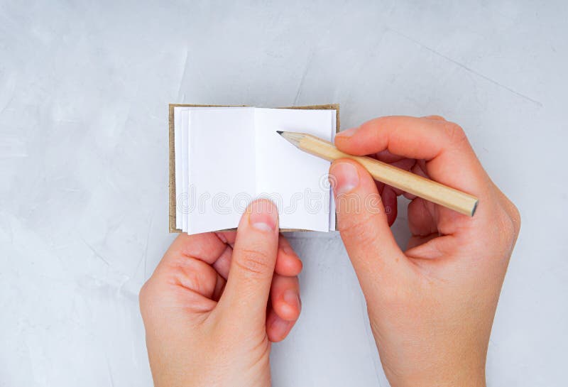 Making Notes in a Miniature Sketchbook on Gray Stock Image - Image of ...