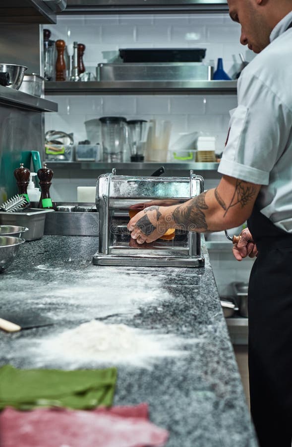 Making Pasta. Vertical Image of Chef`s Hands with Tattoos Rolling a ...