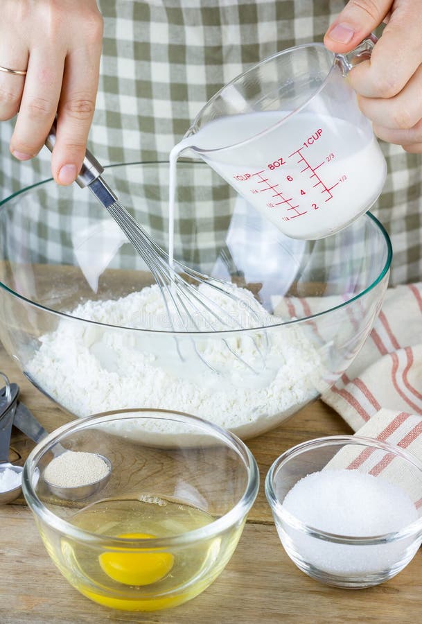 Making Pastry Dough. a Baker Adds a Milk into the Flour. Ingredients ...
