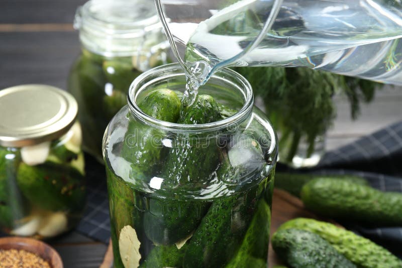 Making Pickles. Pouring Water into Jar with Cucumbers at Table, Closeup ...