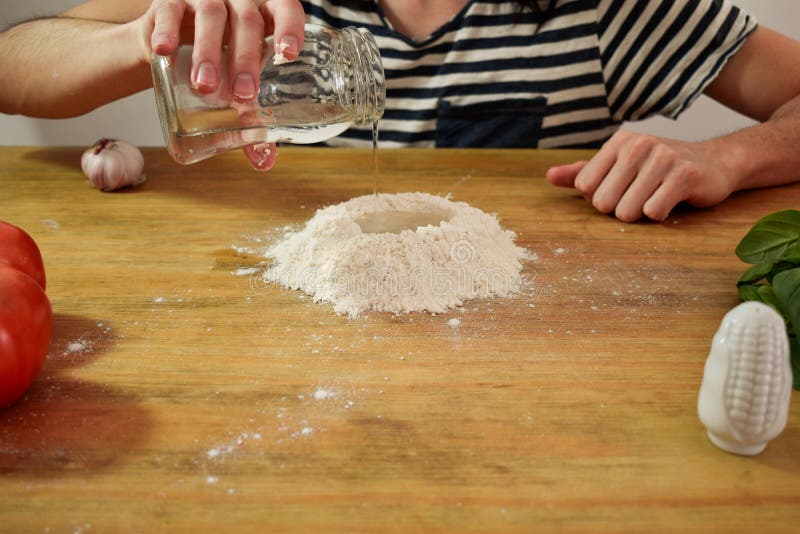 Man Making pizza at home stock photo. Image of dough - 198538168