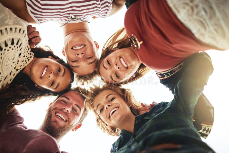 Making Plans on the Beach. Low Angle Portrait of a Group of Friends ...
