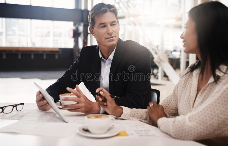 Making Plans Thatll Result in Another Win. Two Businesspeople Working ...