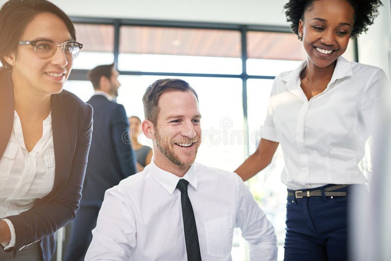 Making Progress. a Group of Businesspeople Gathered Around a Computer ...