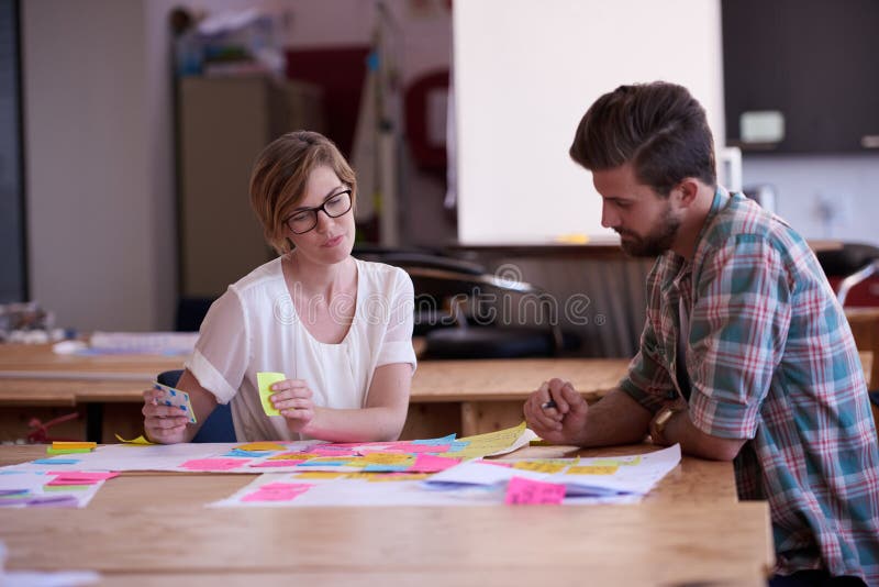 Making the Project Work for Them. a Young Woman Looking at Sticky Notes ...